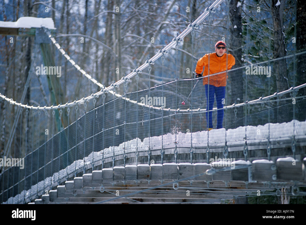 Man crossing bridge on nordic skis Stock Photo - Alamy