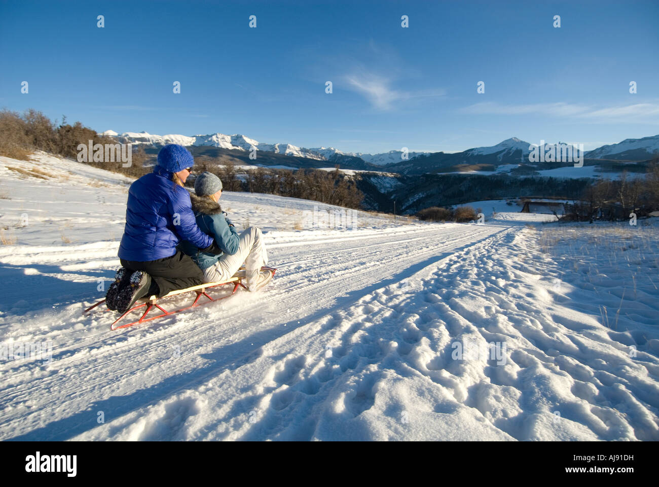 Two women riding a sled Stock Photo - Alamy