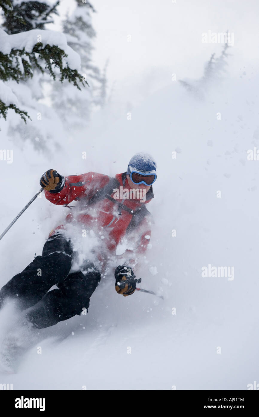 Young man skiing in deep powder Stock Photo - Alamy