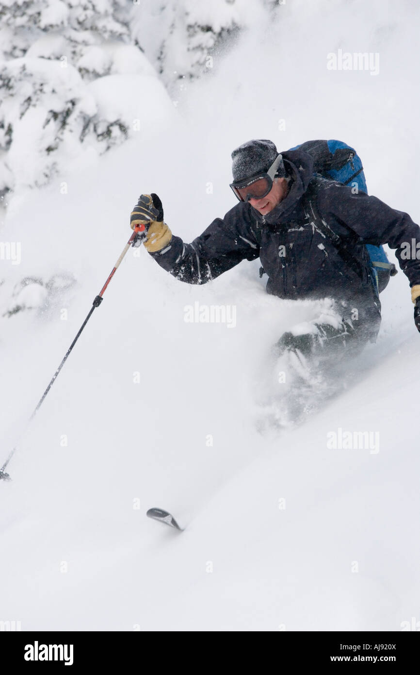 Young man skiing in deep powder Stock Photo - Alamy