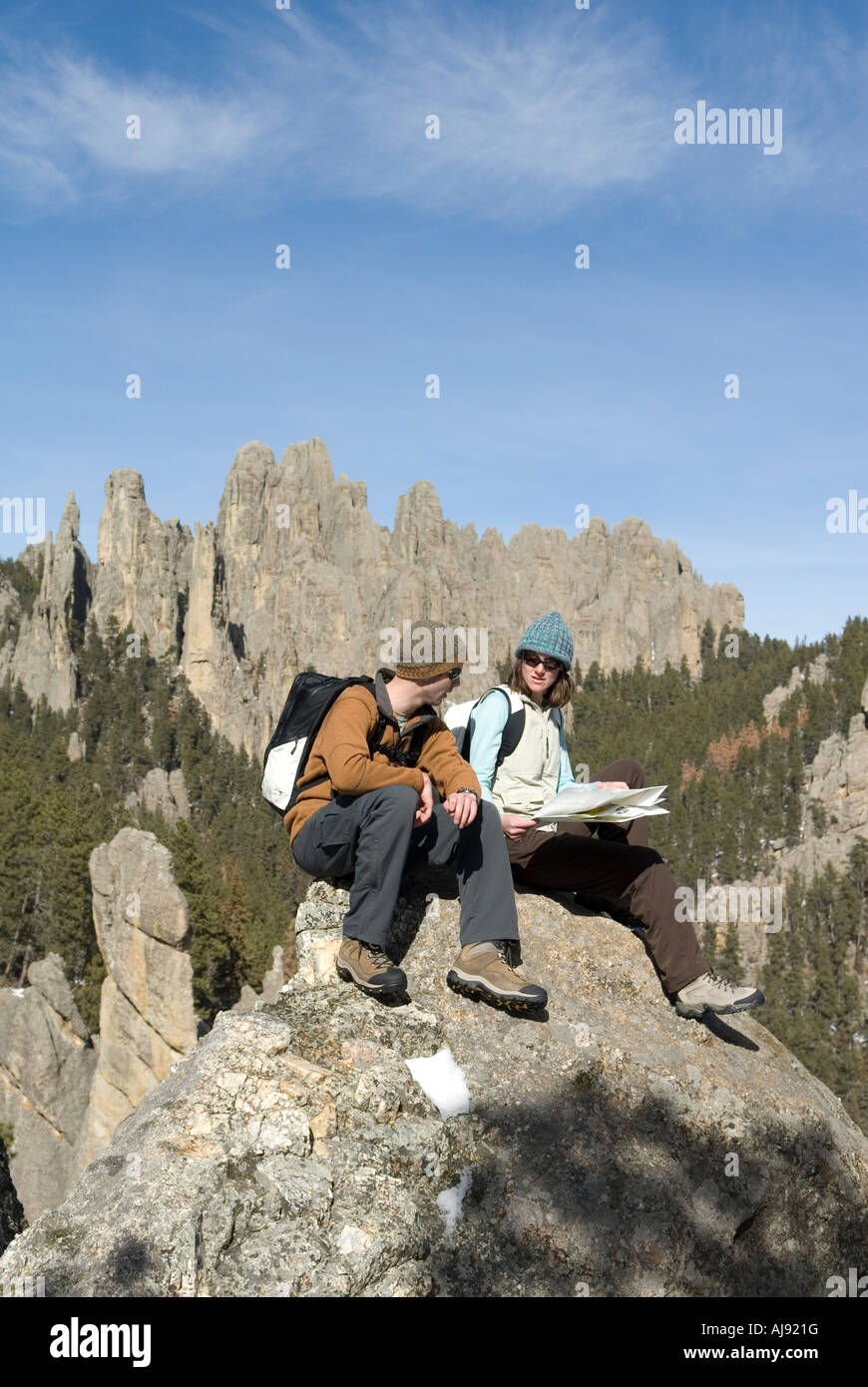 Man and Woman reading map on rock Stock Photo - Alamy