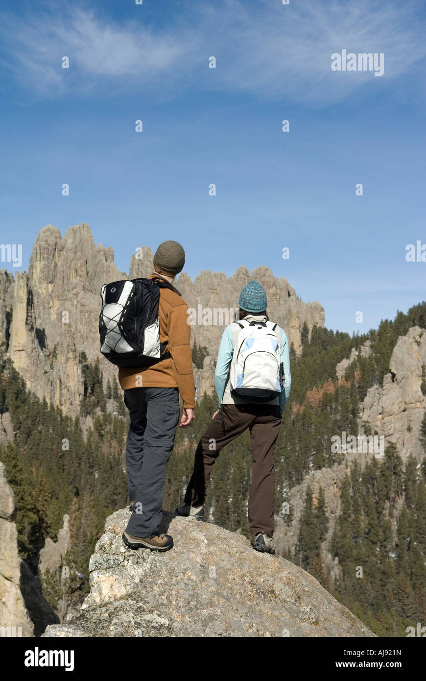 Man and woman standing on rock spire Stock Photo - Alamy