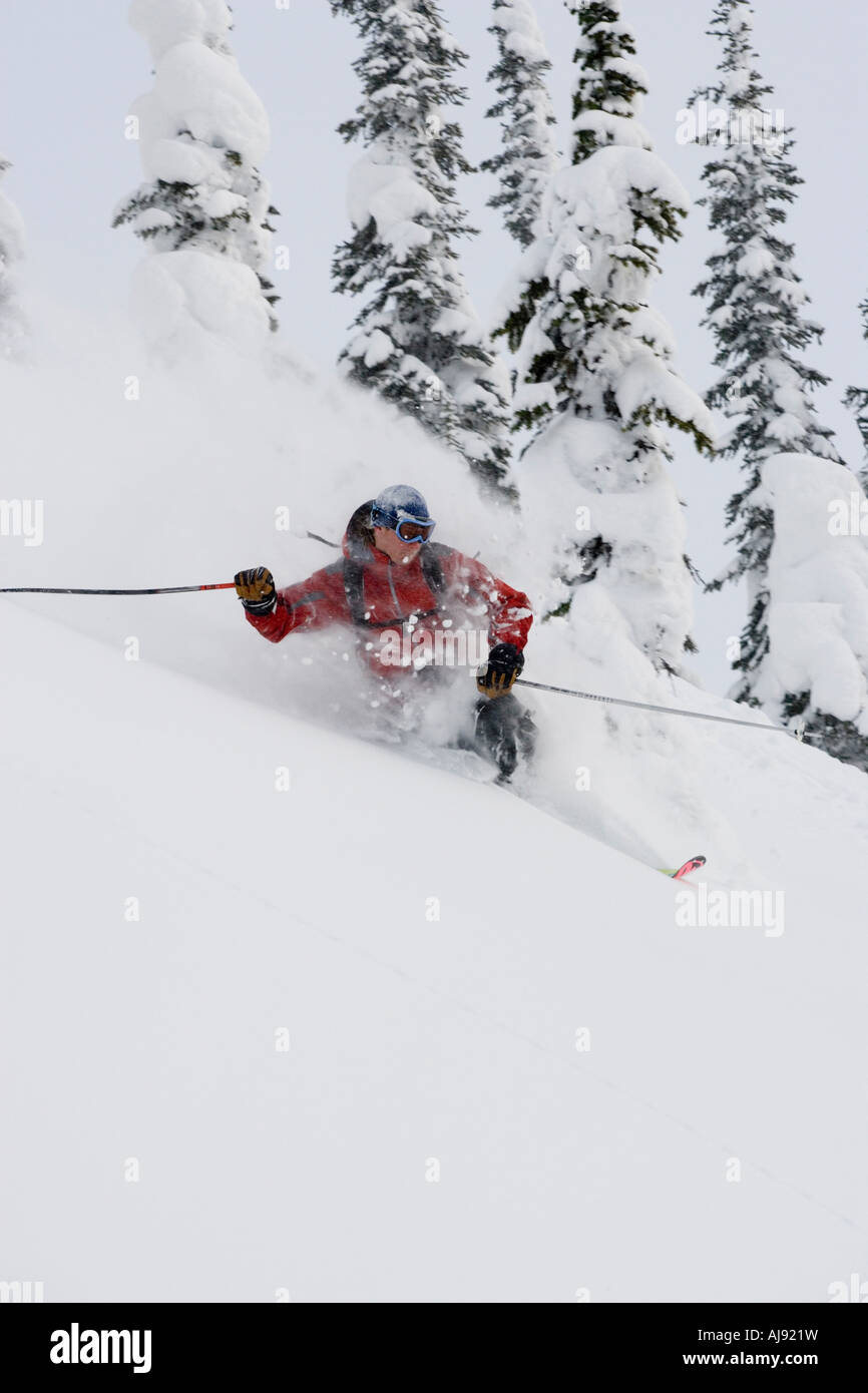 Young man skiing in deep powder Stock Photo - Alamy