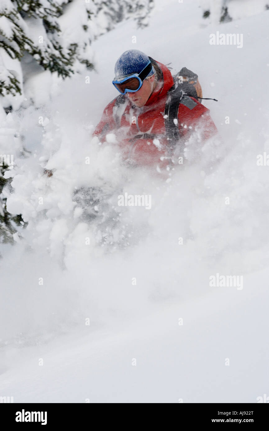 Young man skiing in deep powder Stock Photo - Alamy