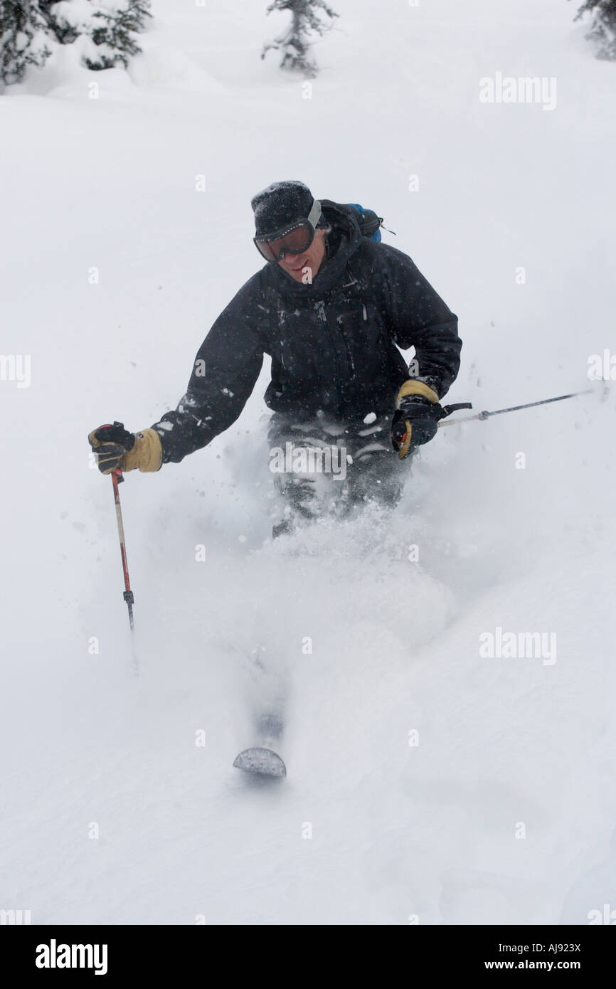 Young man skiing in deep powder Stock Photo - Alamy