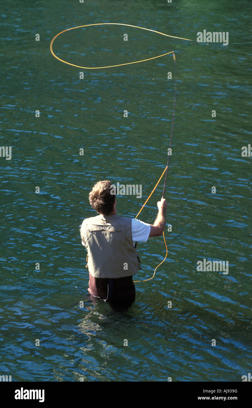 Man casting while fly-fishing Stock Photo - Alamy