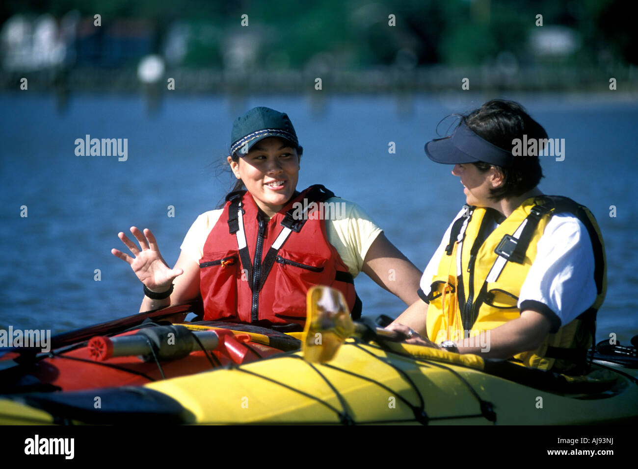 Two women sea kayaking Stock Photo - Alamy