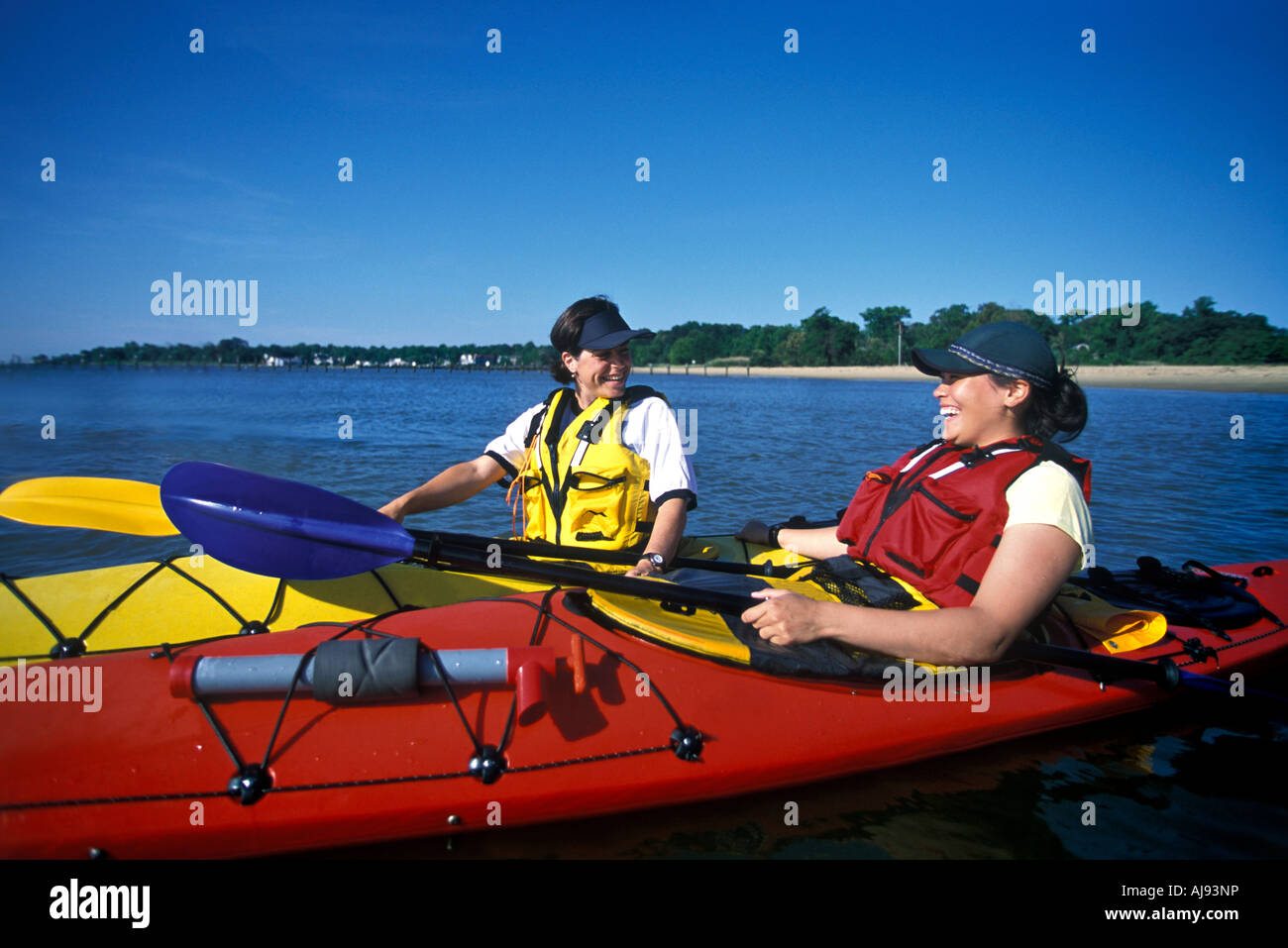 Two women sea kayaking Stock Photo - Alamy