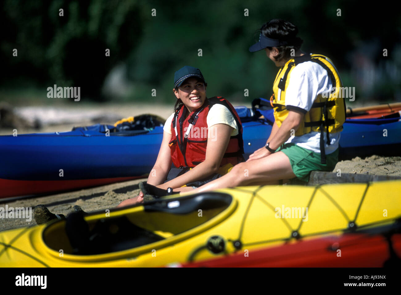 Two women sea kayaking Stock Photo - Alamy