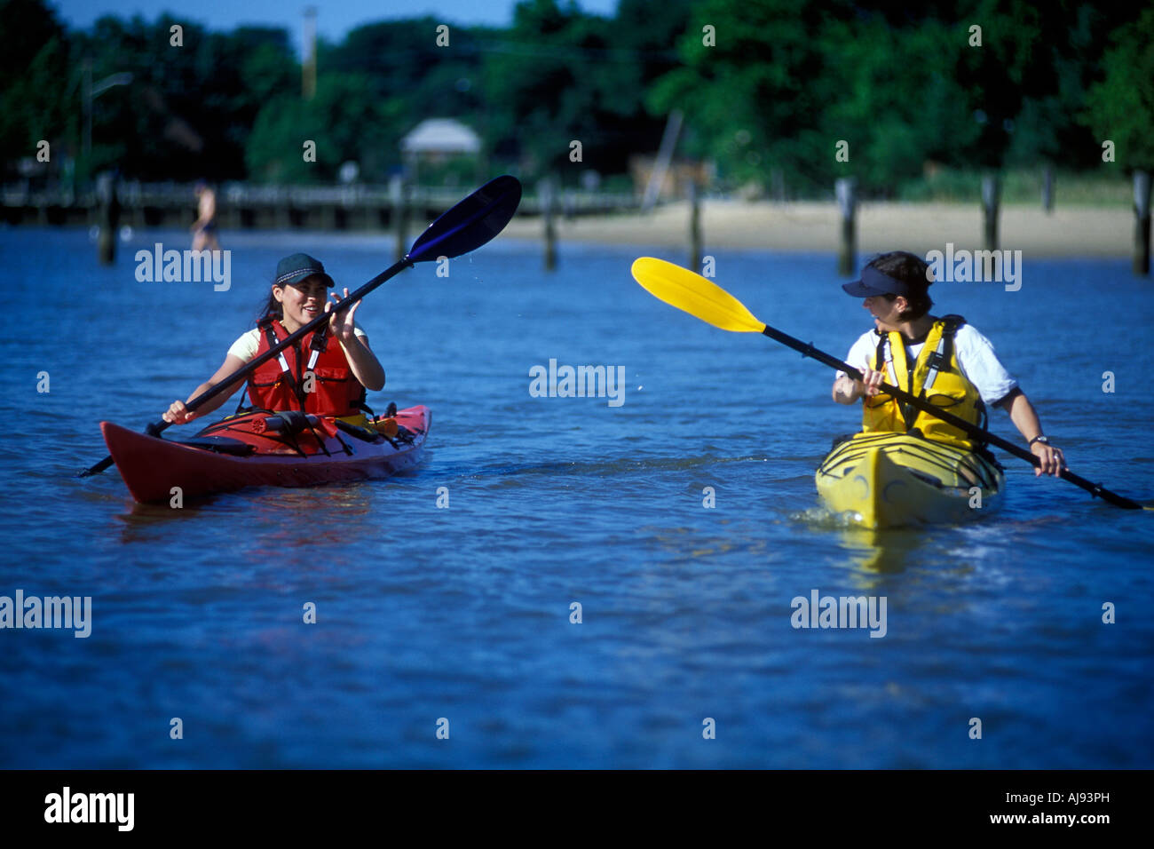 Two women sea kayaking Stock Photo - Alamy