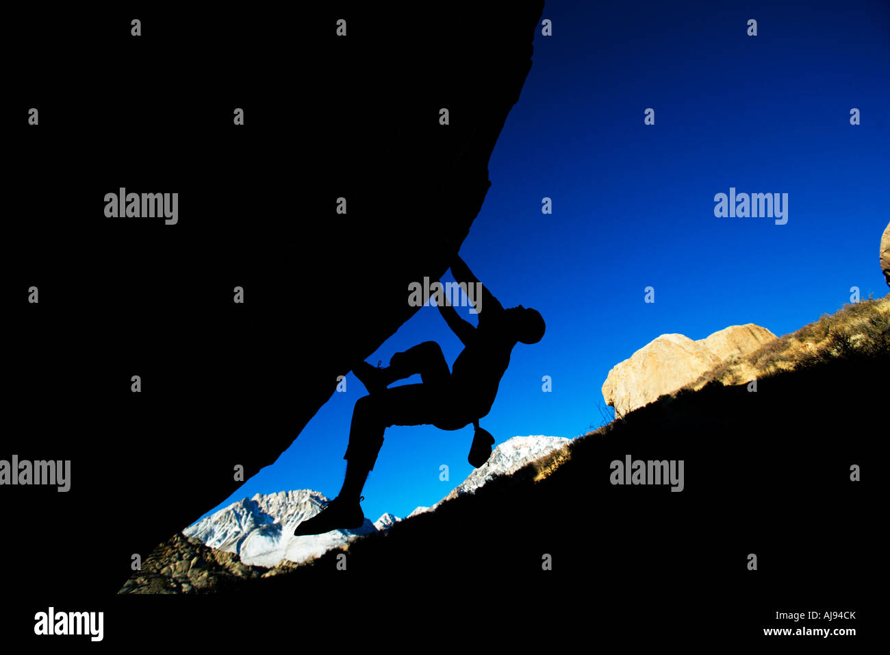 Man bouldering on an overhang Stock Photo - Alamy