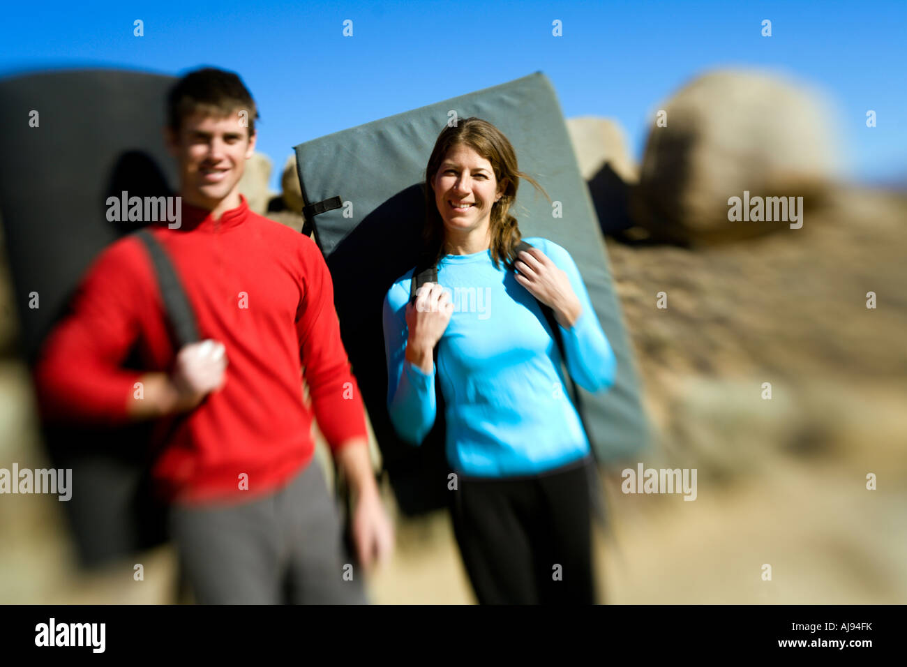 Climbers smiling with crash pads Stock Photo - Alamy