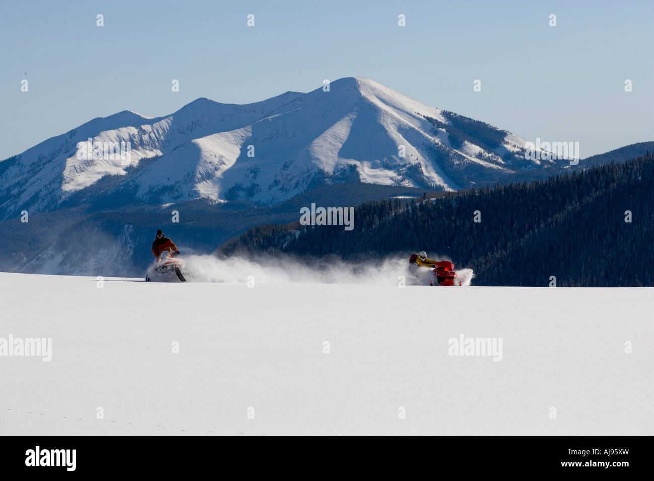 Snowmobiling in the mountains Stock Photo - Alamy