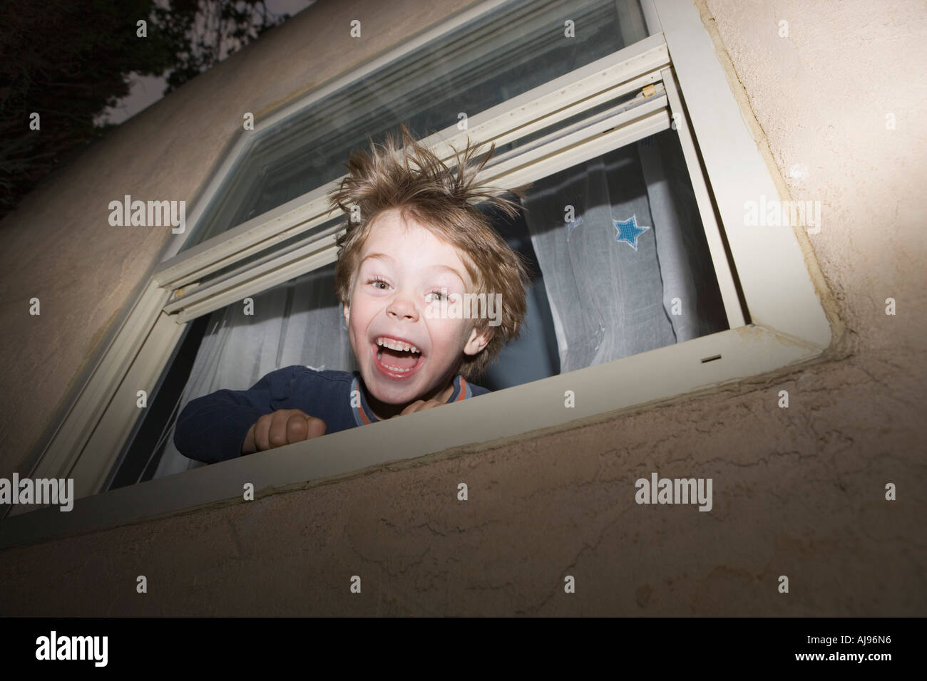 Boy looking out window night hi-res stock photography and images - Alamy