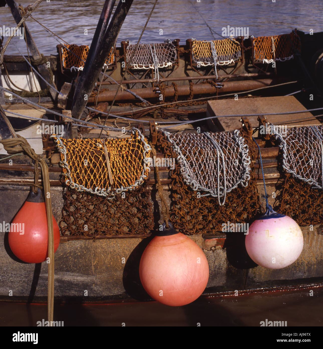 Scallop nets and buoys on fishing boat in West Bay Harbour Dorset ...