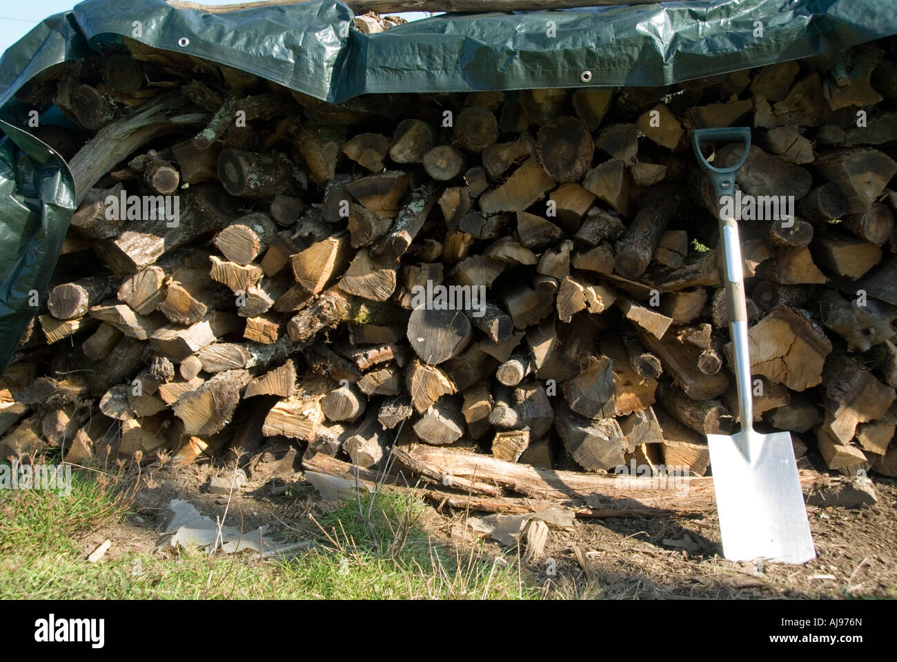 Photo of a log pile to be used for heating fuel The image shows the log ...