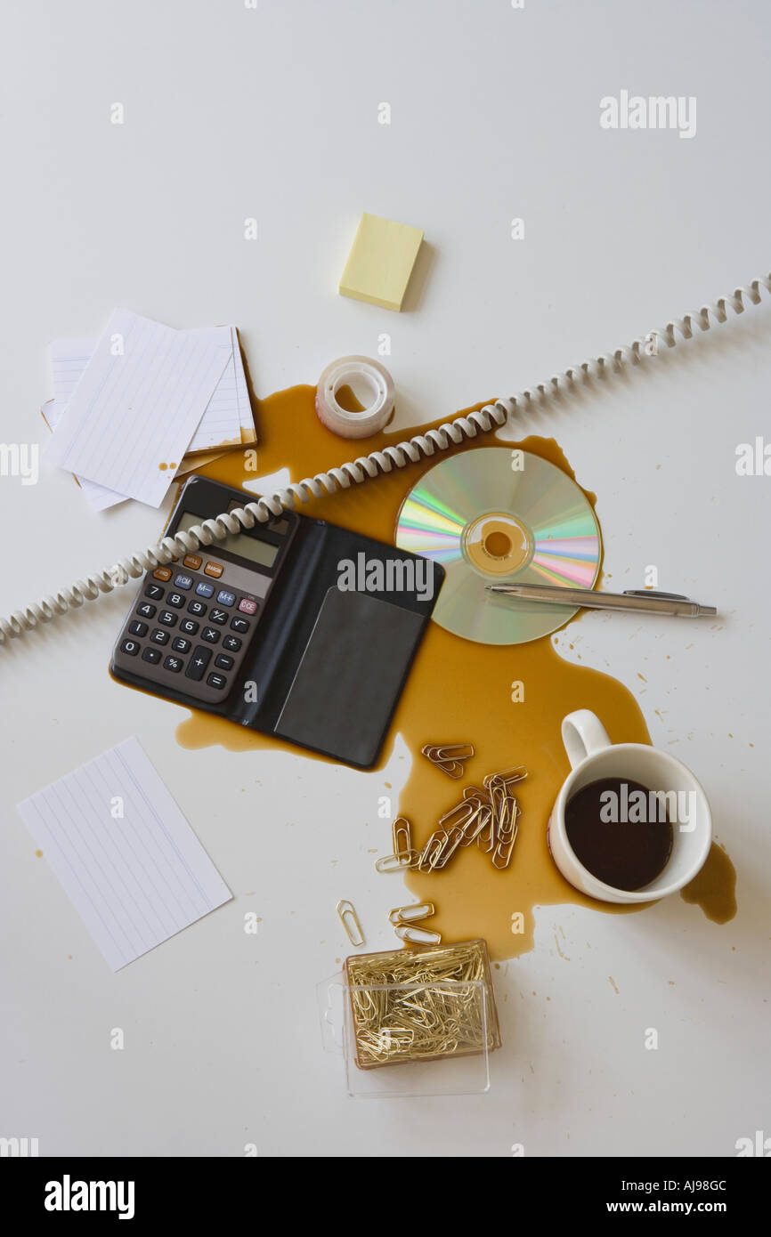 Coffee spilt over messy desk Stock Photo - Alamy