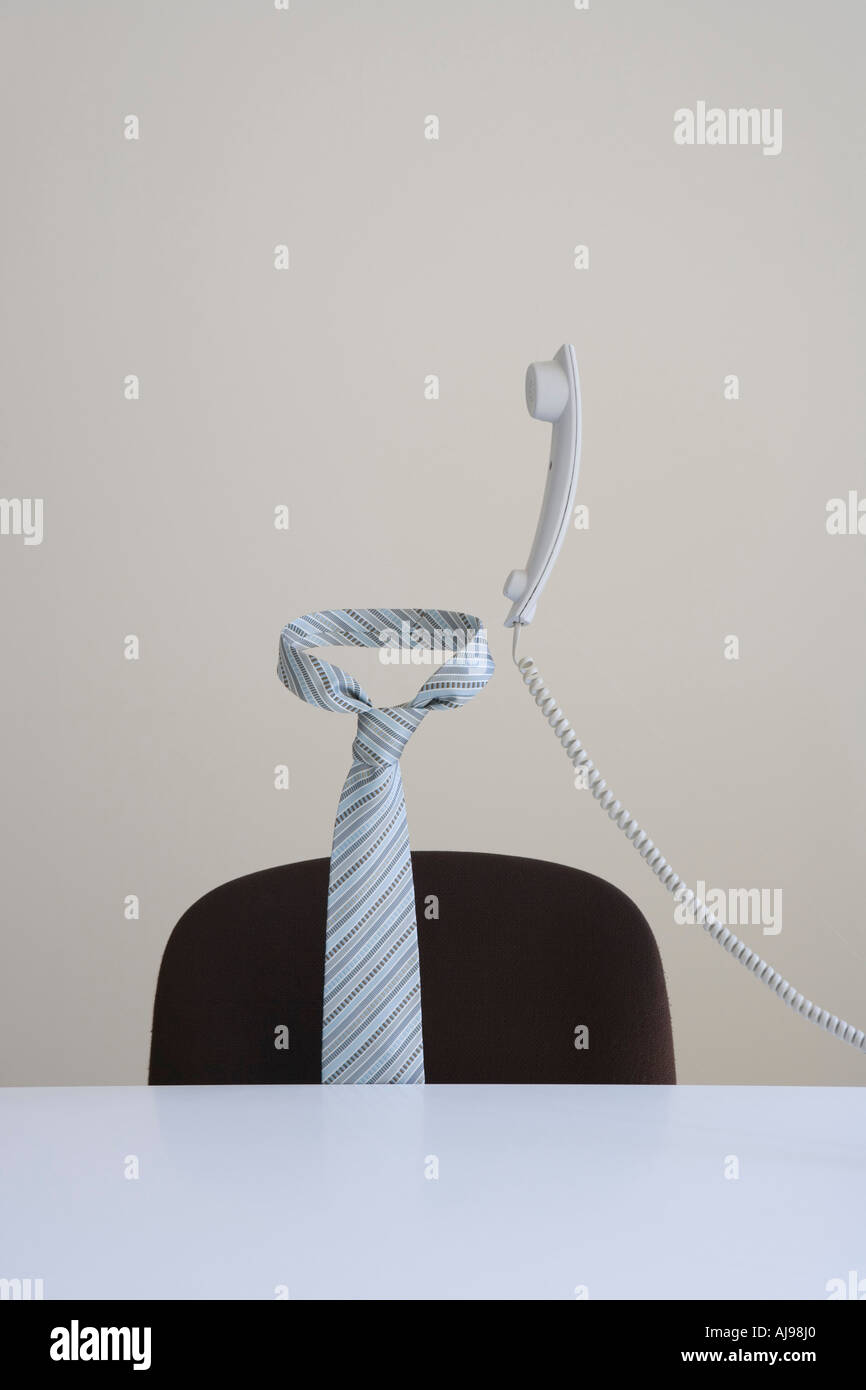 Tie and telephone floating mid air behind desk Stock Photo - Alamy