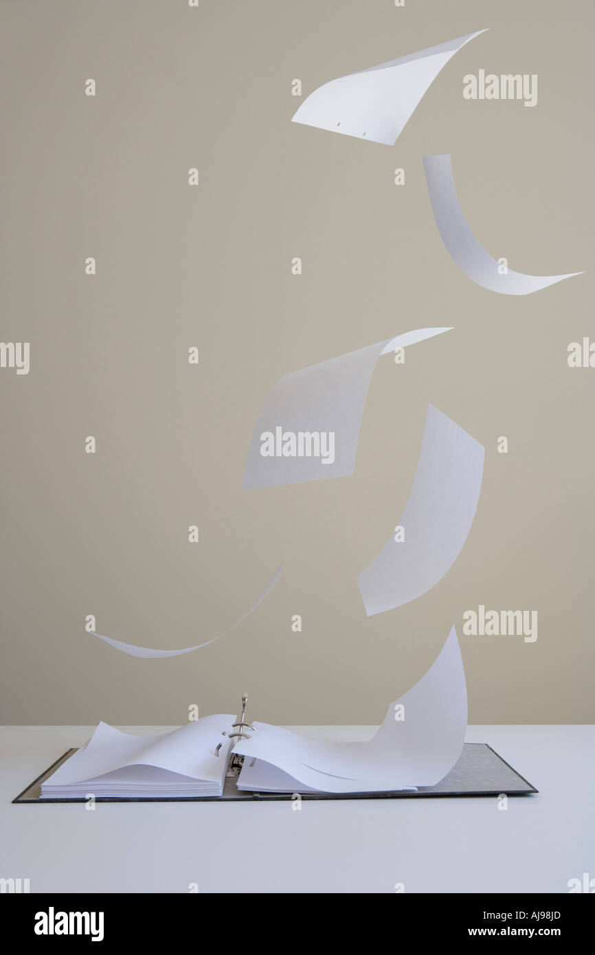 Paper blowing out of ring binder and floating in mid air Stock Photo ...