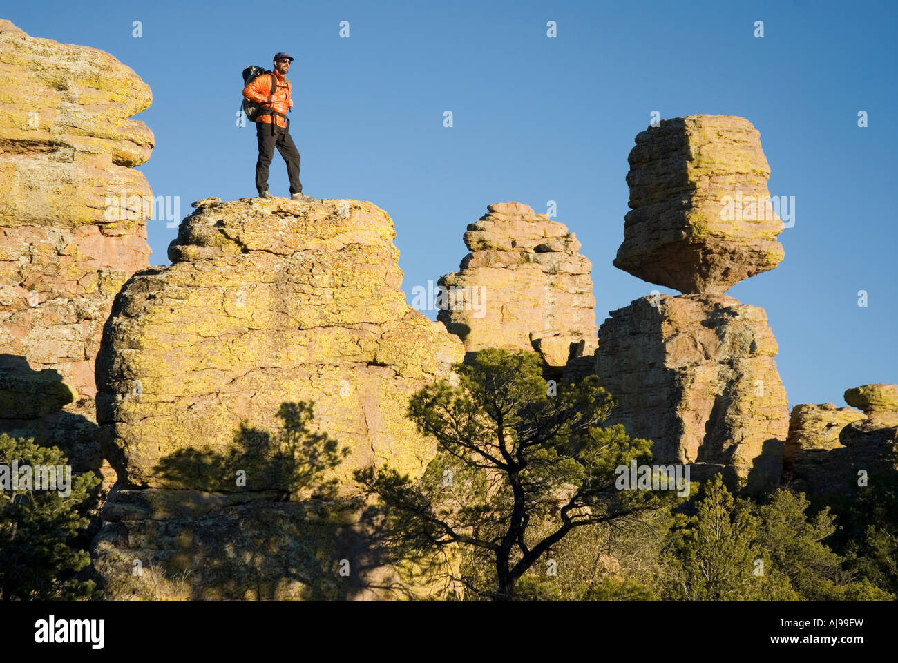 Man stands on rock near Balanced Rock Stock Photo - Alamy