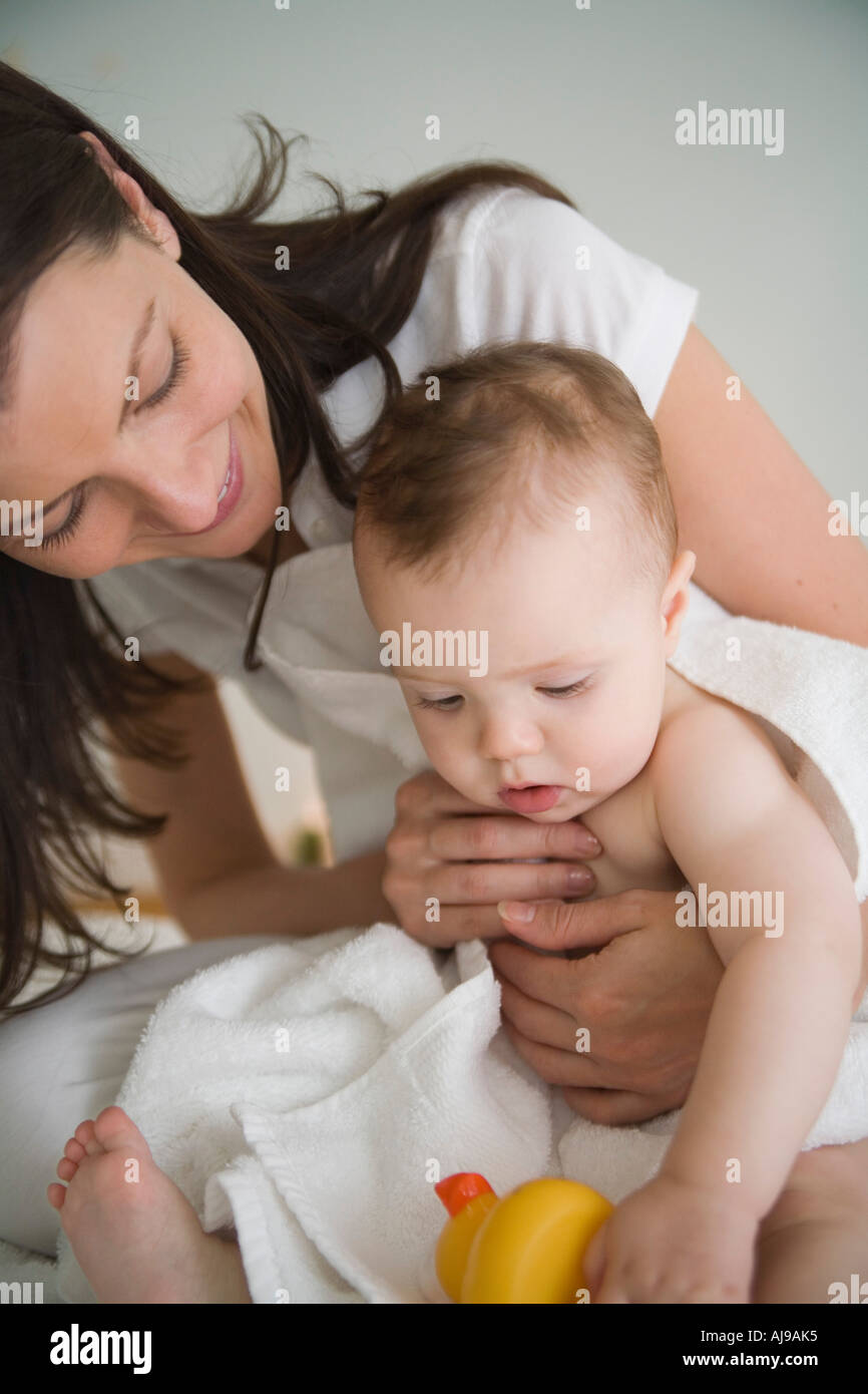 Mother drying baby with a towel Stock Photo - Alamy