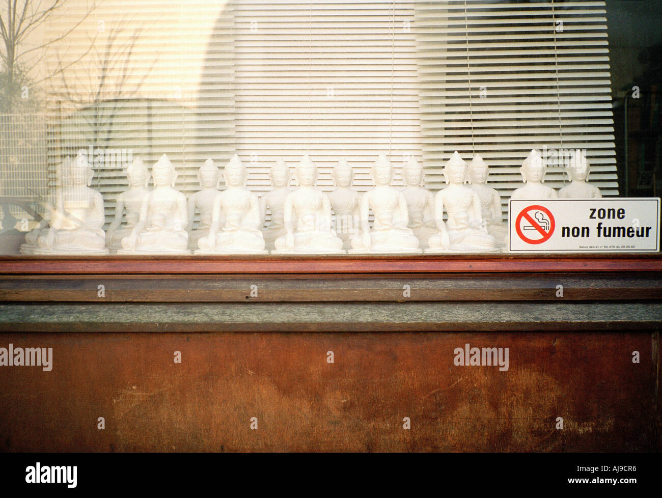 Buddha statues in window display Stock Photo - Alamy