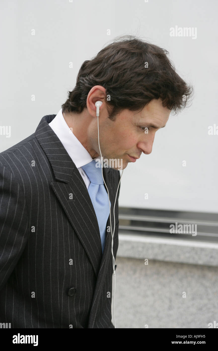 An English businessman listening to headphones Stock Photo - Alamy
