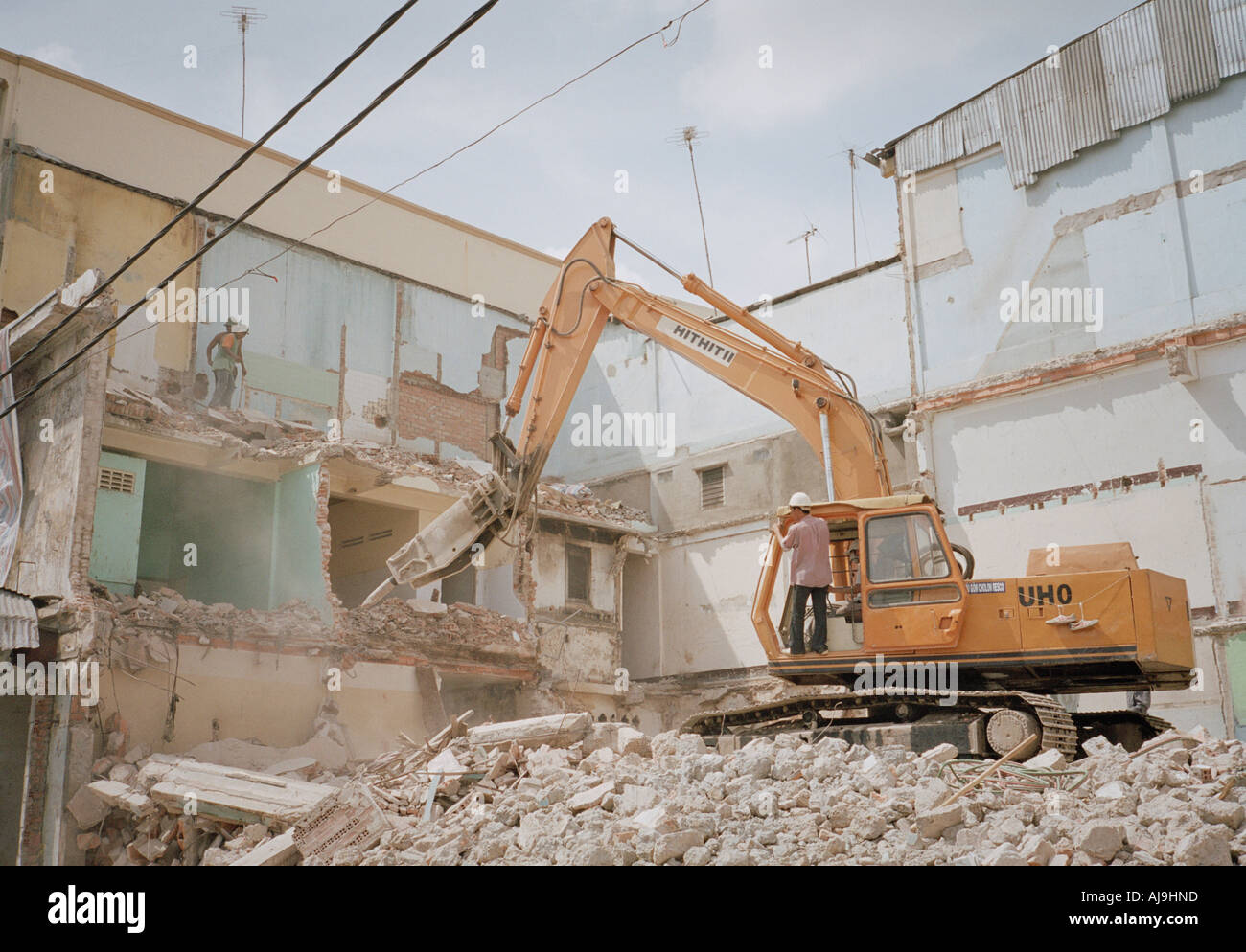 Earth mover being used for building demolition Stock Photo - Alamy