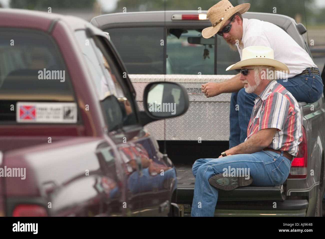 Cowboys in the back of a pick-up truck Stock Photo - Alamy