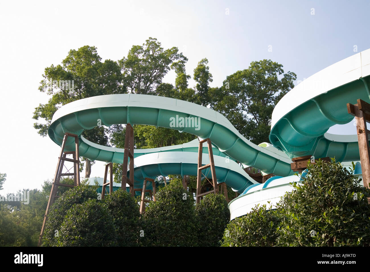 Water slide curving between plants and trees Stock Photo - Alamy
