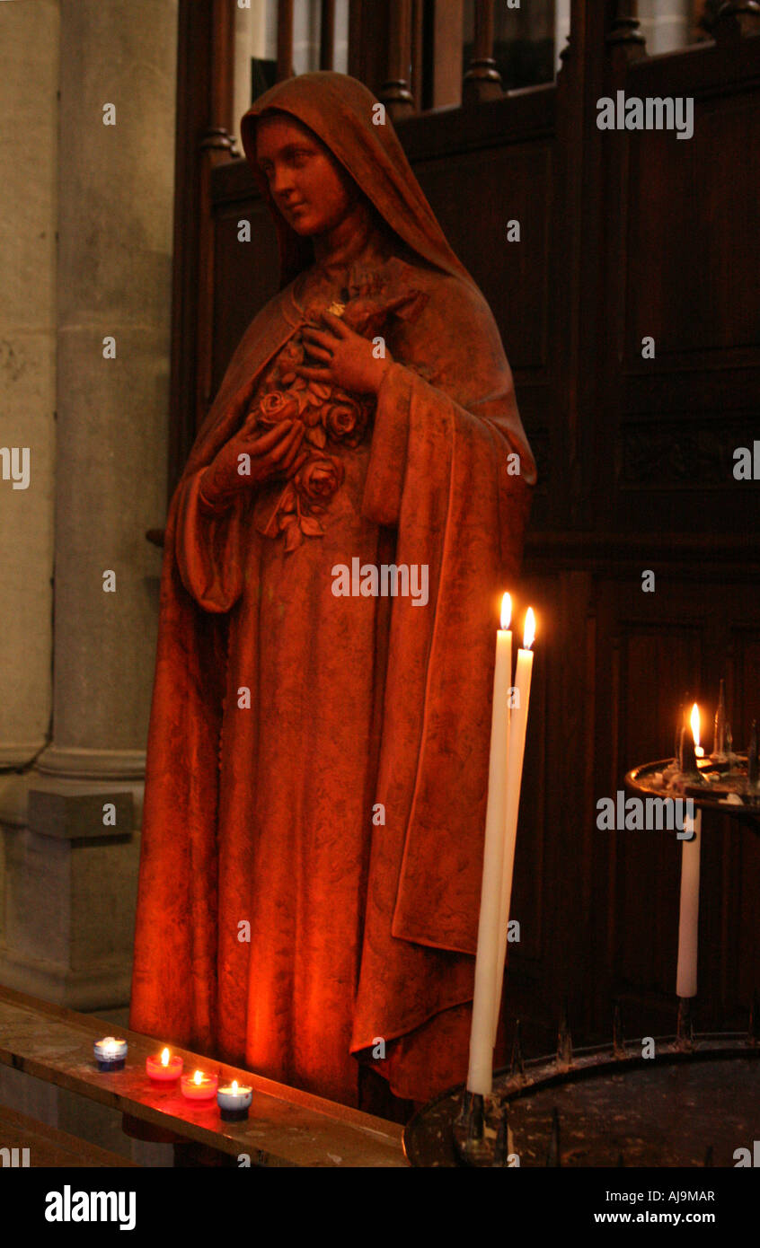 Virgin Mary glowing red in candle light inside the interior of ...