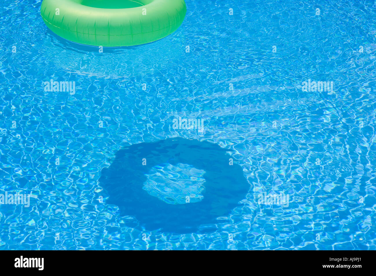 An inflatable tube floating in a swimming pool Stock Photo - Alamy