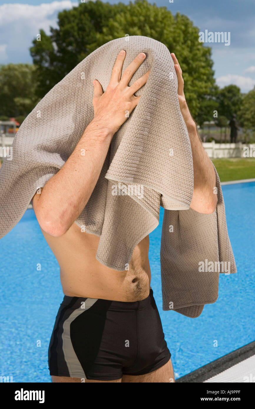 A man drying himself off after swimming Stock Photo - Alamy