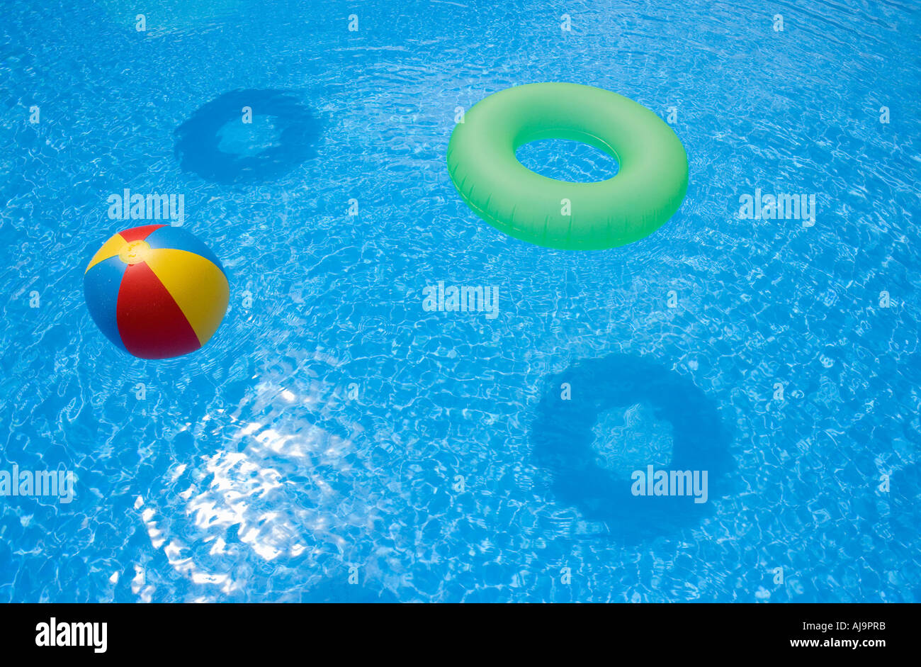 An inflatable ball and ring floating in a swimming pool Stock Photo - Alamy
