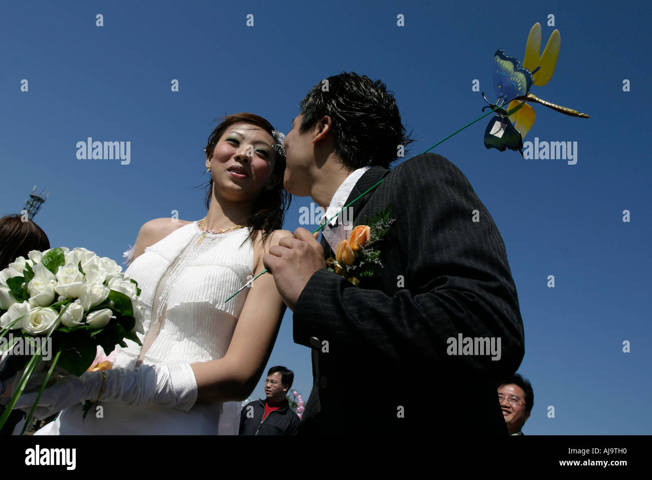 Boy and girl attending group wedding in Asia Stock Photo - Alamy