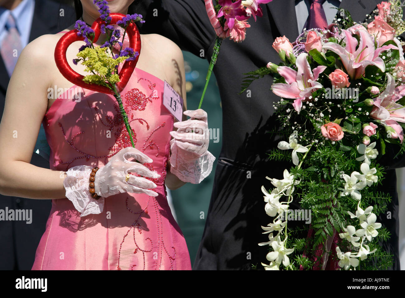 Groom and bride attending group wedding in Asia Stock Photo - Alamy