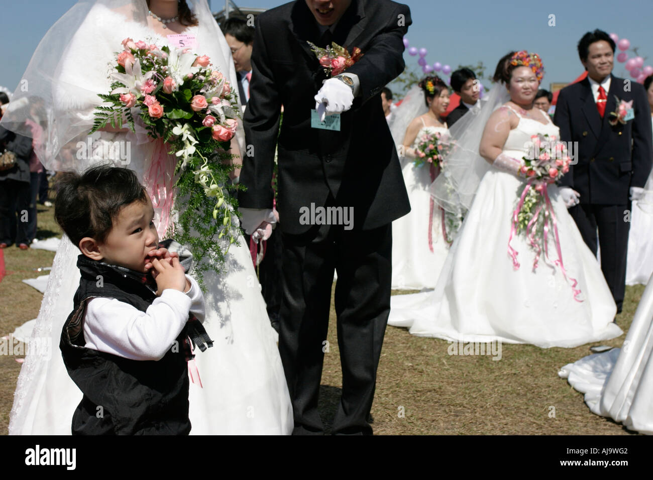 Boy attending group wedding in Asia Stock Photo - Alamy