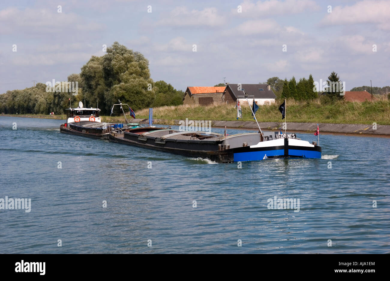 Tug barge pushing another commercial barge on the Canal du Nord in ...