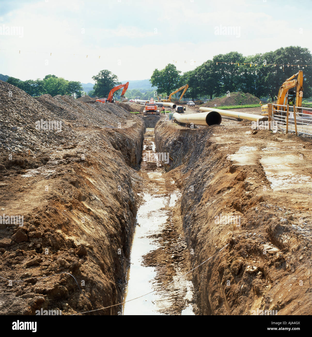 Muddy trench dug in preparation for the new gas pipeline being laid in ...