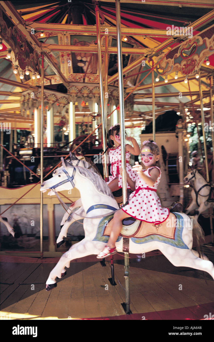 Girls riding merry go round hi-res stock photography and images - Alamy