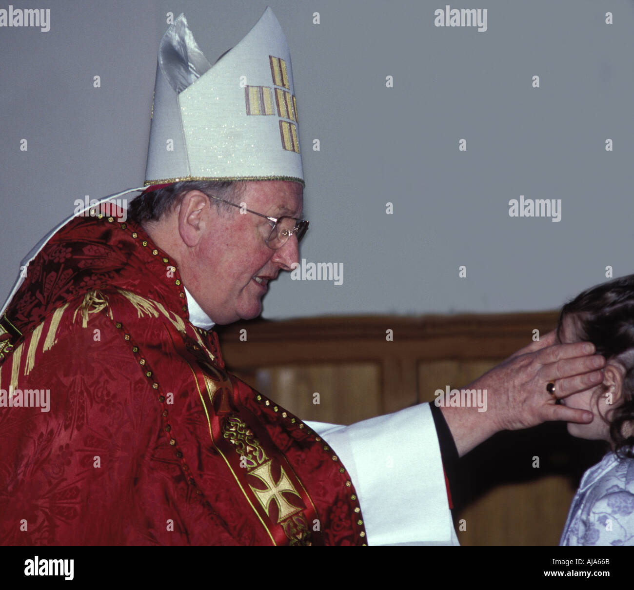 Bishop confirming a child Stock Photo - Alamy
