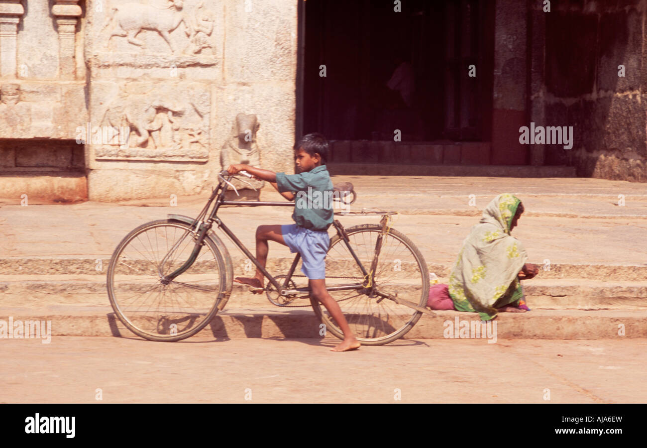 young boy pushing bike dusty street, India Stock Photo - Alamy