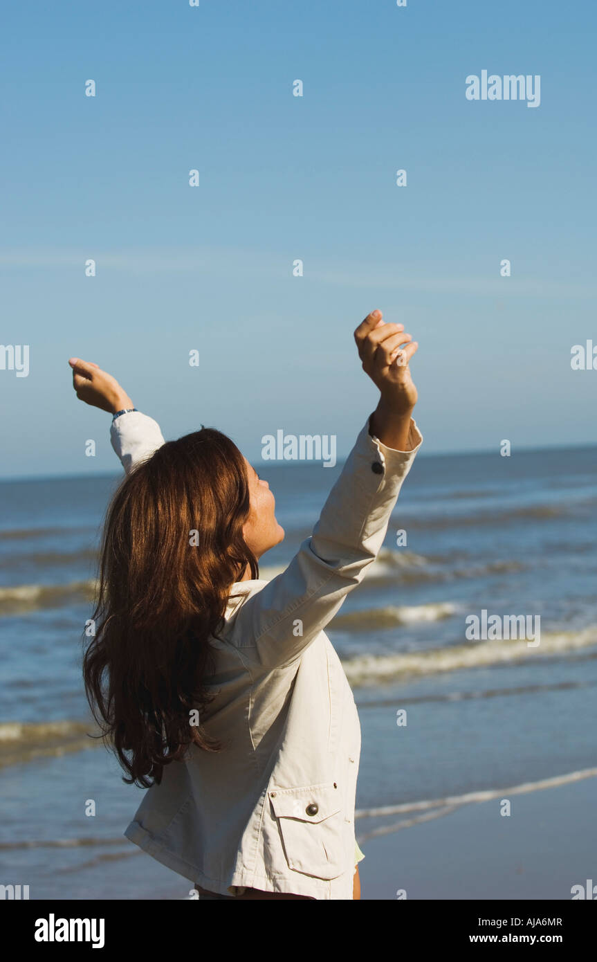 woman stretching arms out on beach Stock Photo - Alamy