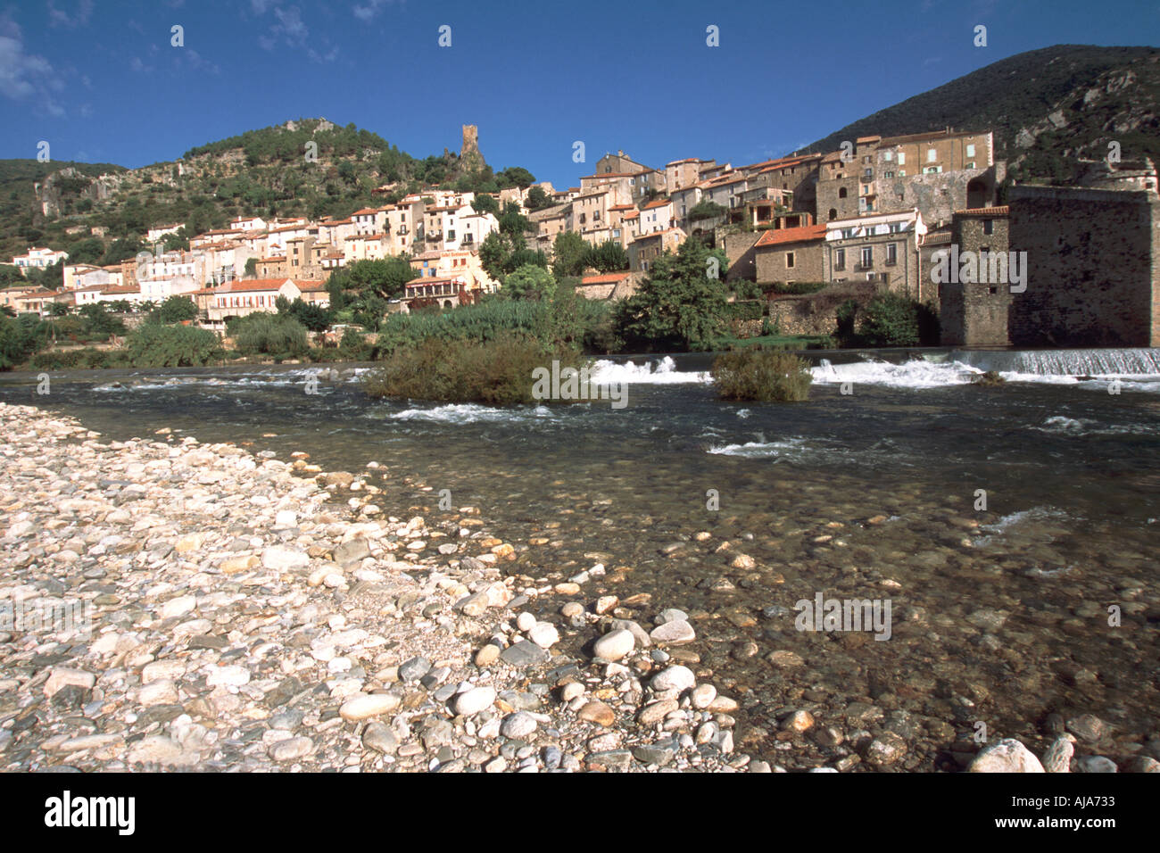 The picturesque hillside village of Roquebrun by the River Orb, Herault ...