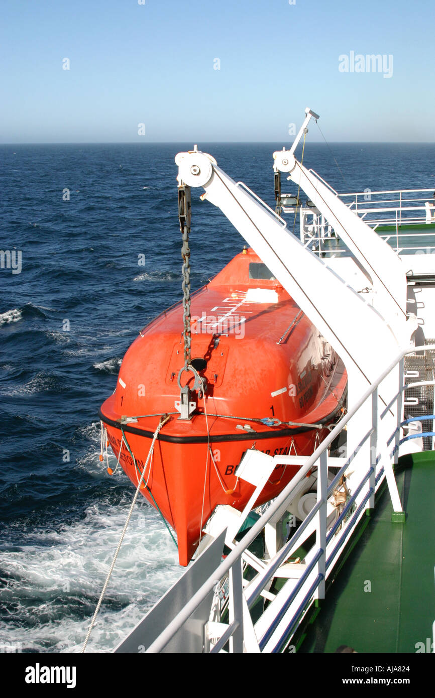 Cruise ships life boat on it s derrick Stock Photo - Alamy