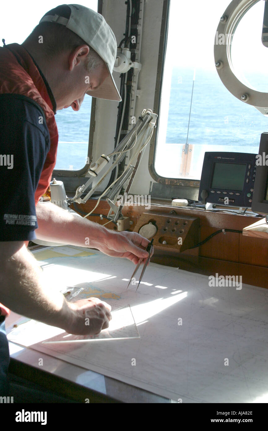 Navigator standing over charts working out the ships course Stock Photo ...