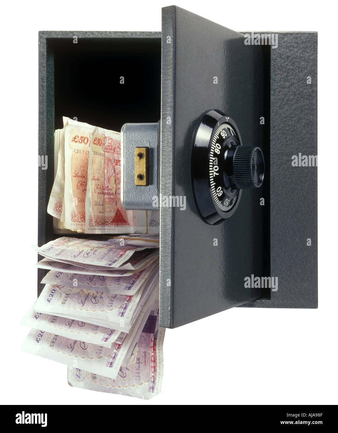 Safe with combination dial with money pouring out Stock Photo - Alamy