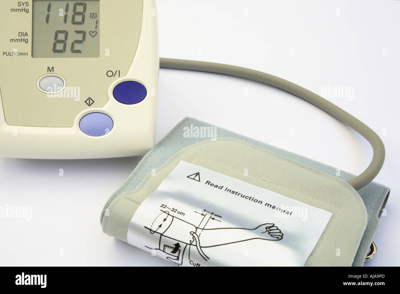 Close up of a digital blood pressure monitor on a white background ...