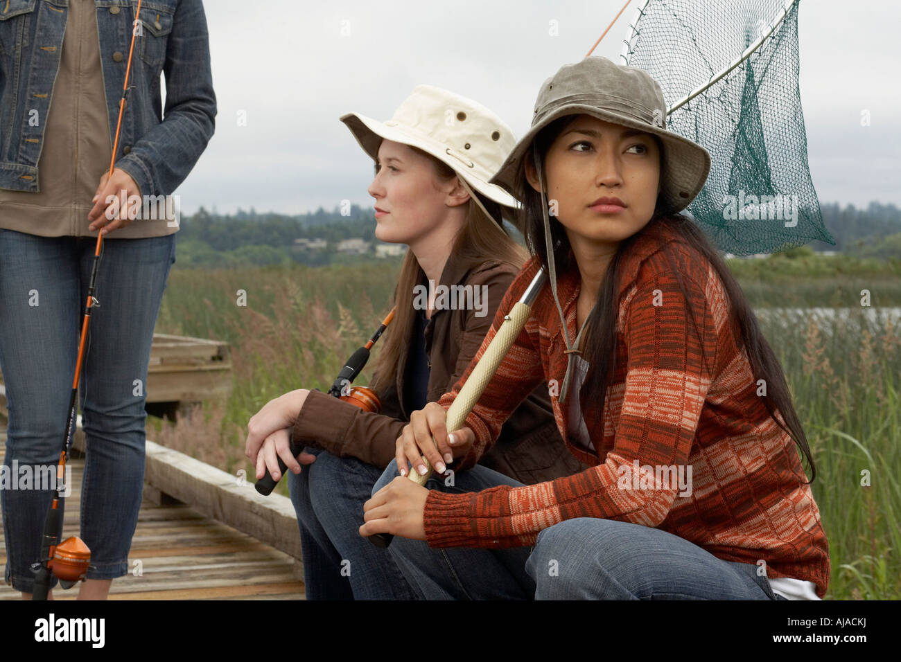Young woman holding fishing pole hi-res stock photography and images ...