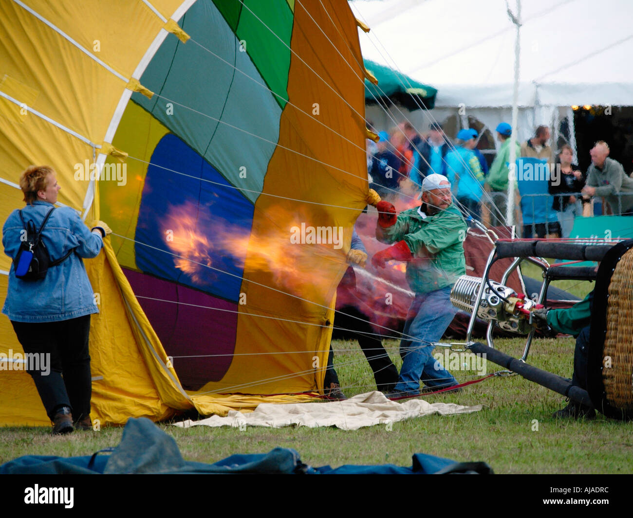 People preparing hot air balloons for flight by heating the cold air ...